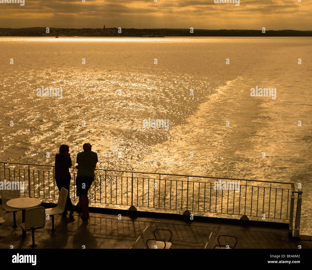 Couple looking out to sea aboard a ship Stock Photo - Alamy