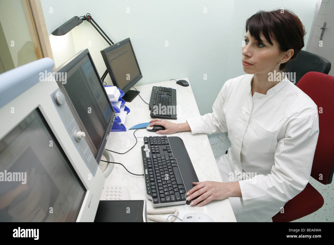 Operators operating computer tomography facility Stock Photo - Alamy