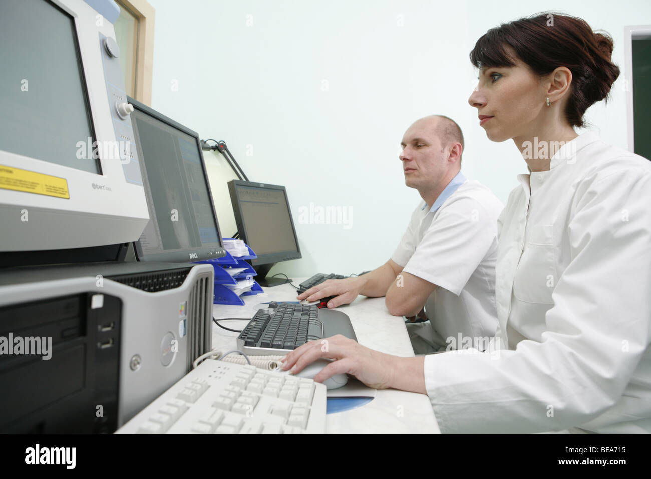 Operators operating computer tomography facility Stock Photo - Alamy