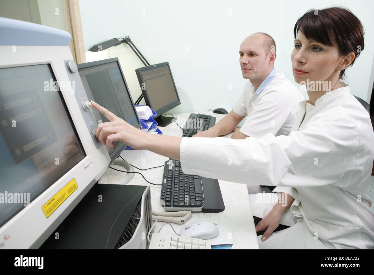 Operators operating computer tomography facility Stock Photo - Alamy