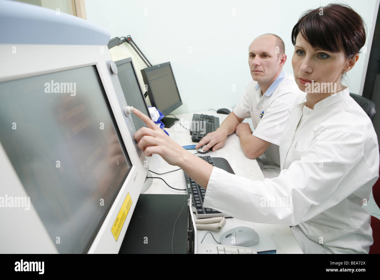 Operators operating computer tomography facility Stock Photo - Alamy