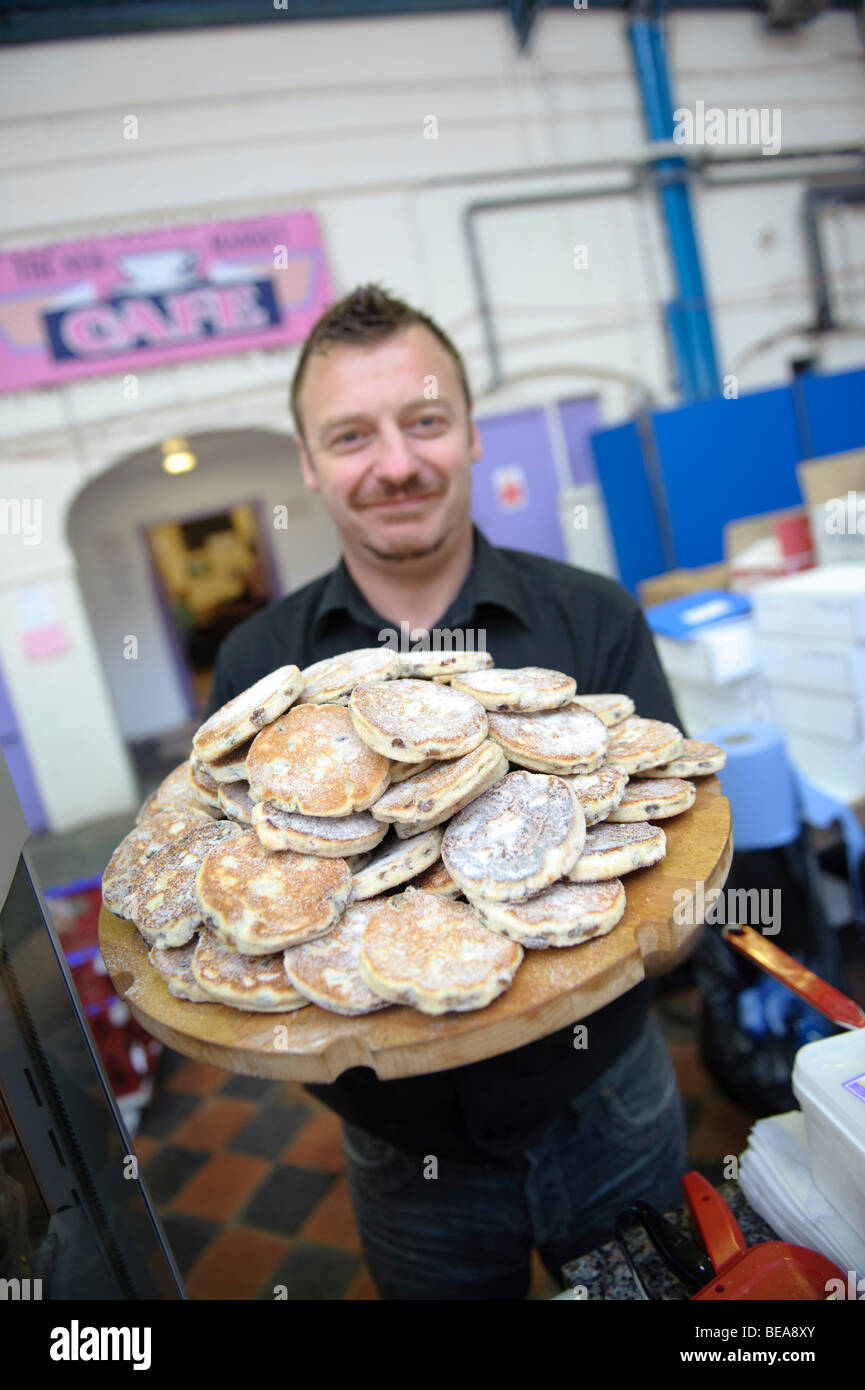 A man holding a platter of freshly cooked welsh cakes at the ...