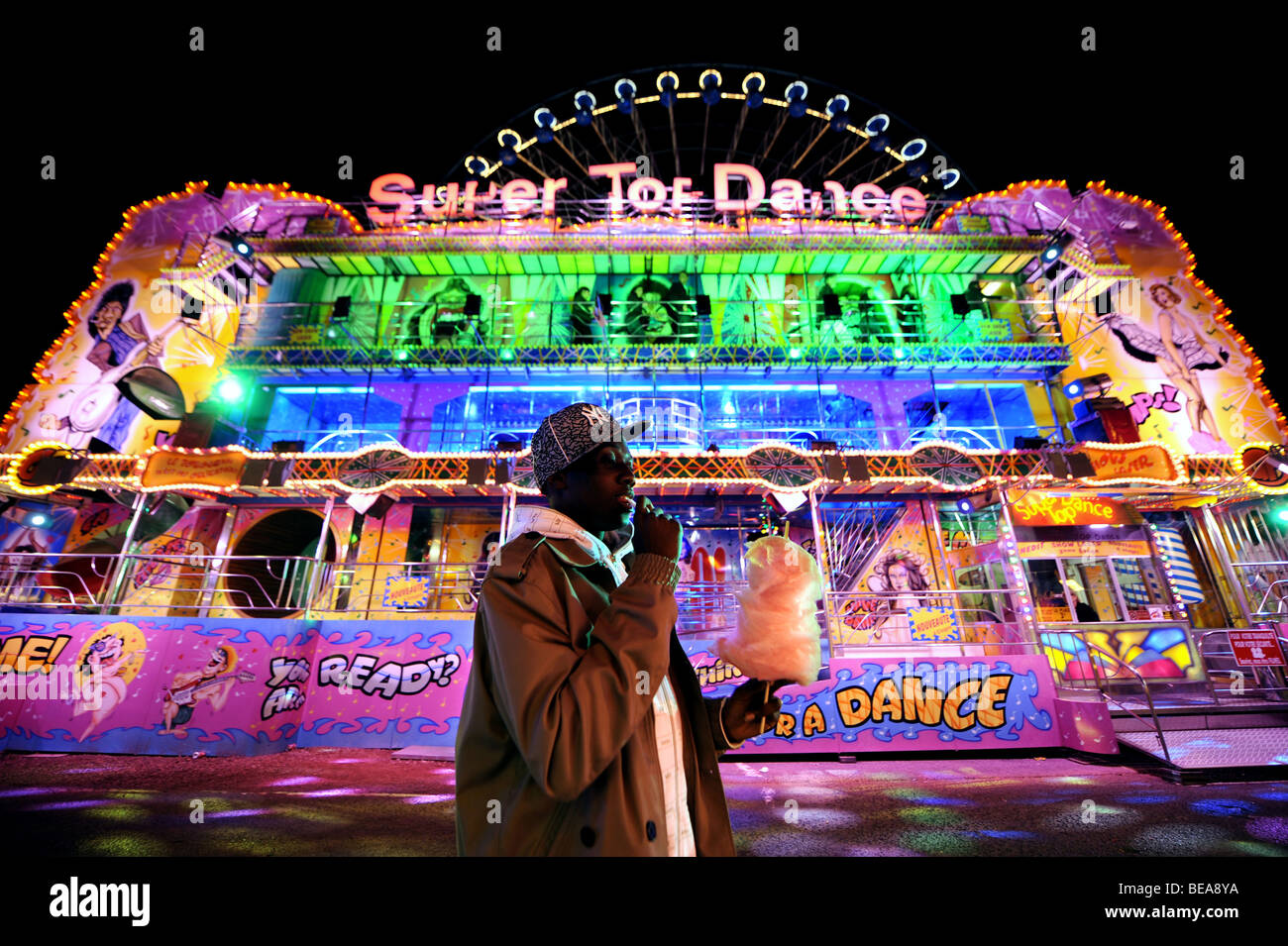 Fun fair: teenager eating cotton candy Stock Photo - Alamy