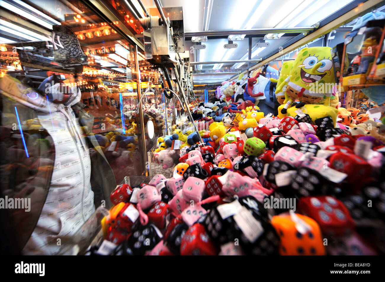 Fun fair: teenager in front of an attraction Stock Photo - Alamy