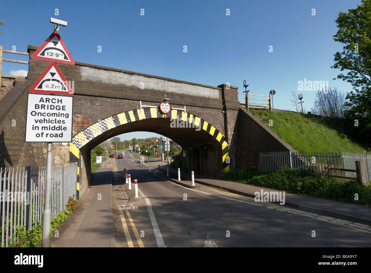 Road markings guiding traffic single file beneath a height restricted ...