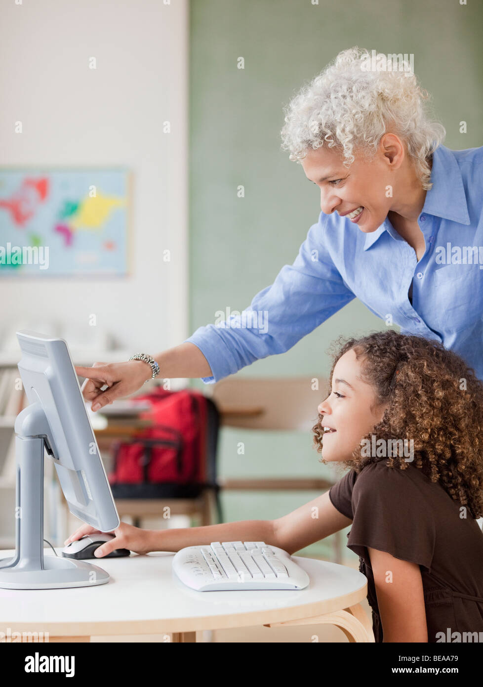 Teacher and student using computer Stock Photo - Alamy