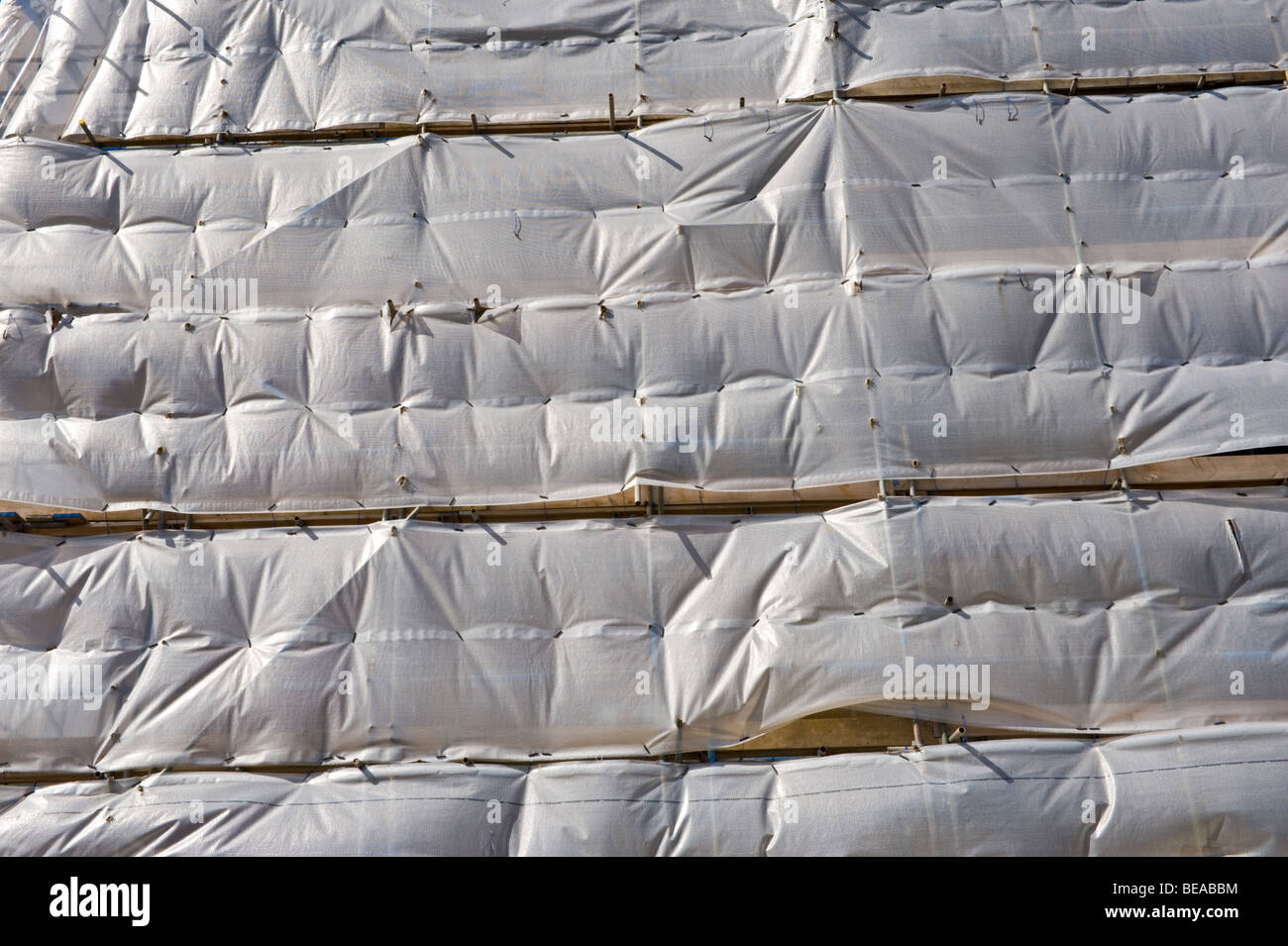 Building being renovated covered in plastic sheet Newport South Wales ...