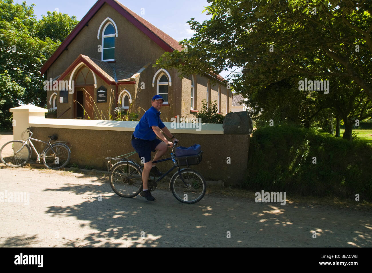 dh SARK SARK ISLAND Local postman delivering post by bicycle Stock ...