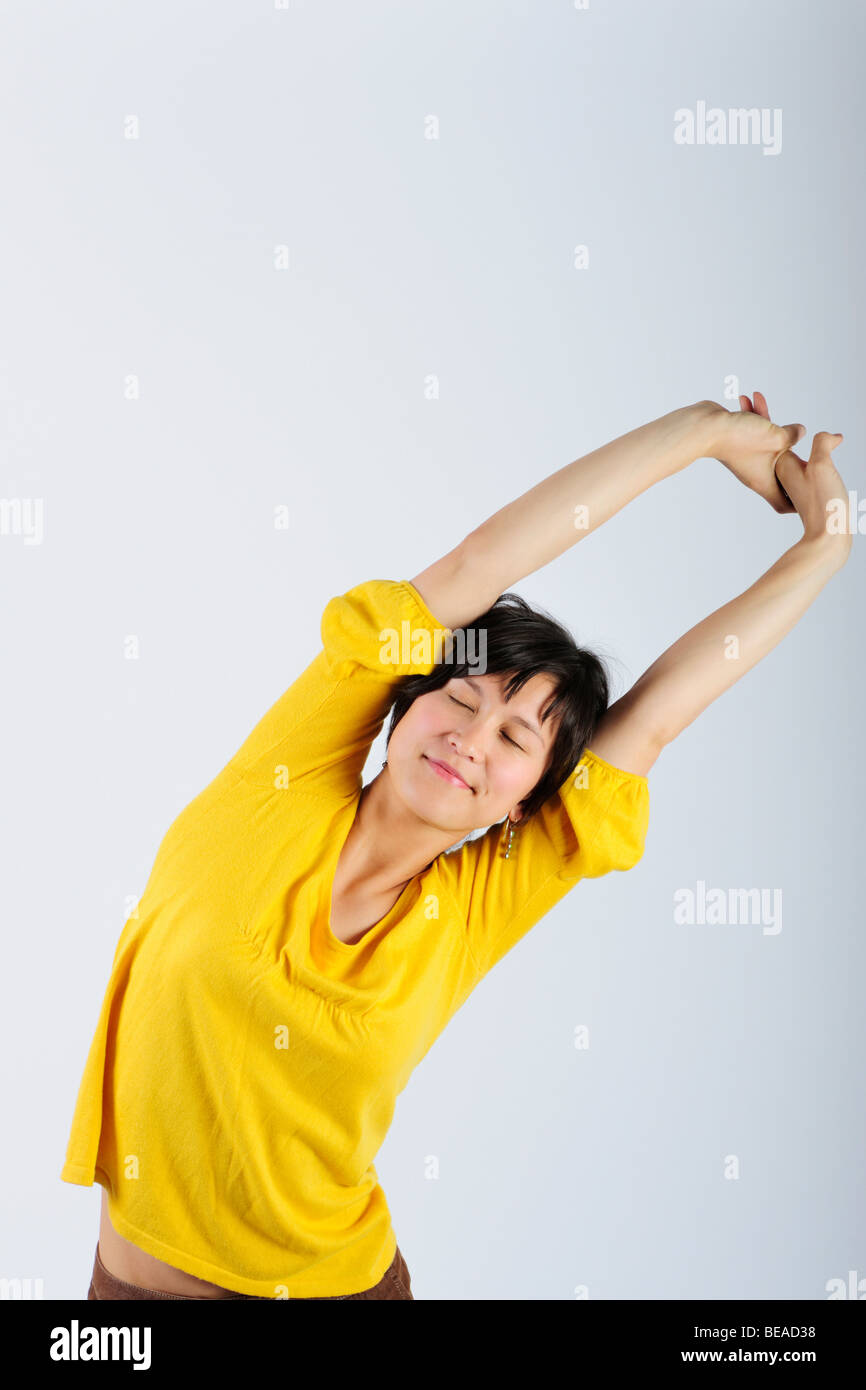 Filipino woman stretching arms overhead Stock Photo - Alamy