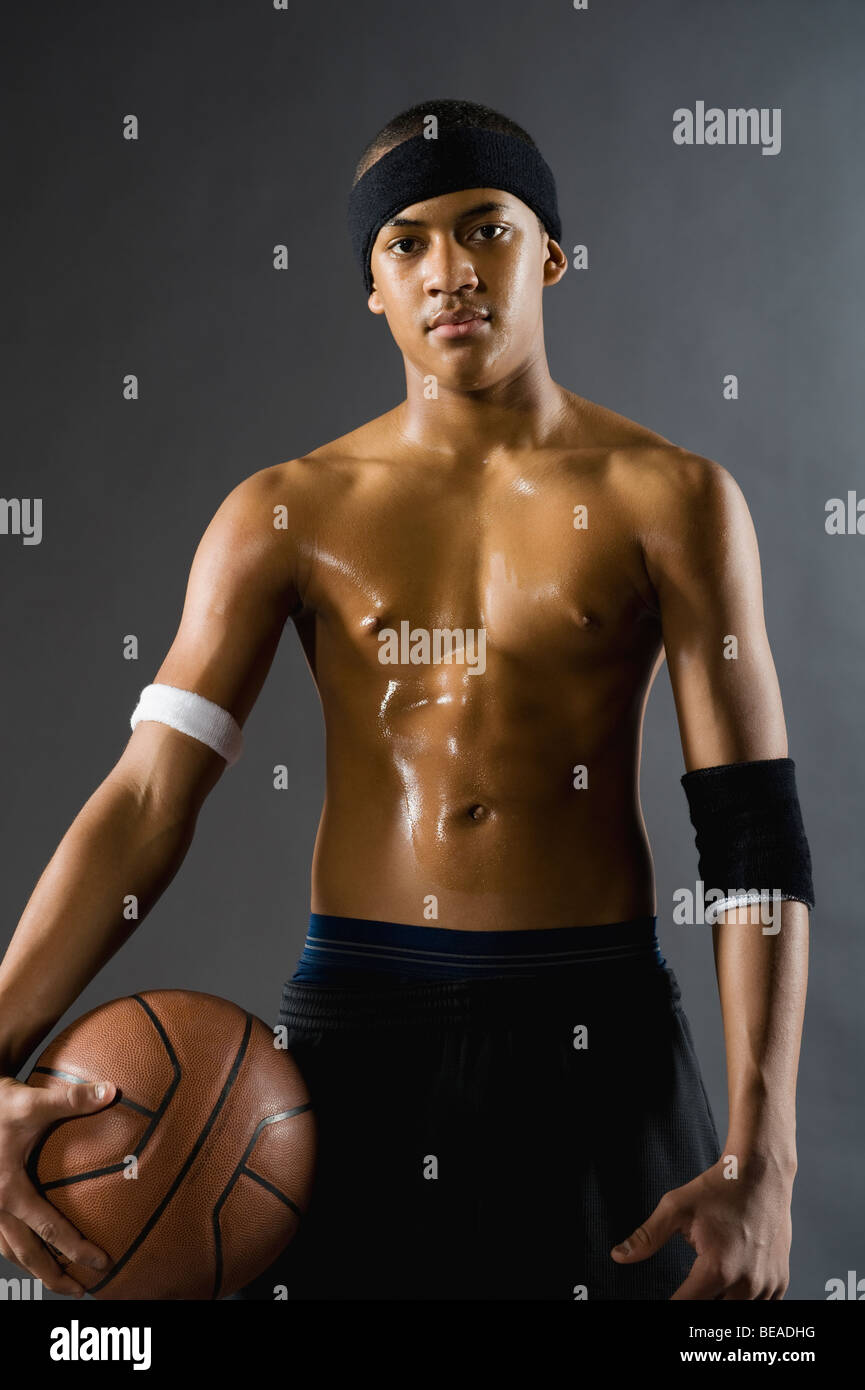 Mixed race basketball player holding ball Stock Photo - Alamy