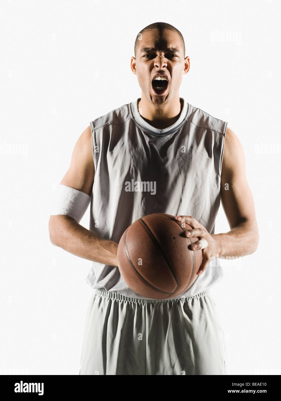 Angry African man holding basketball Stock Photo - Alamy