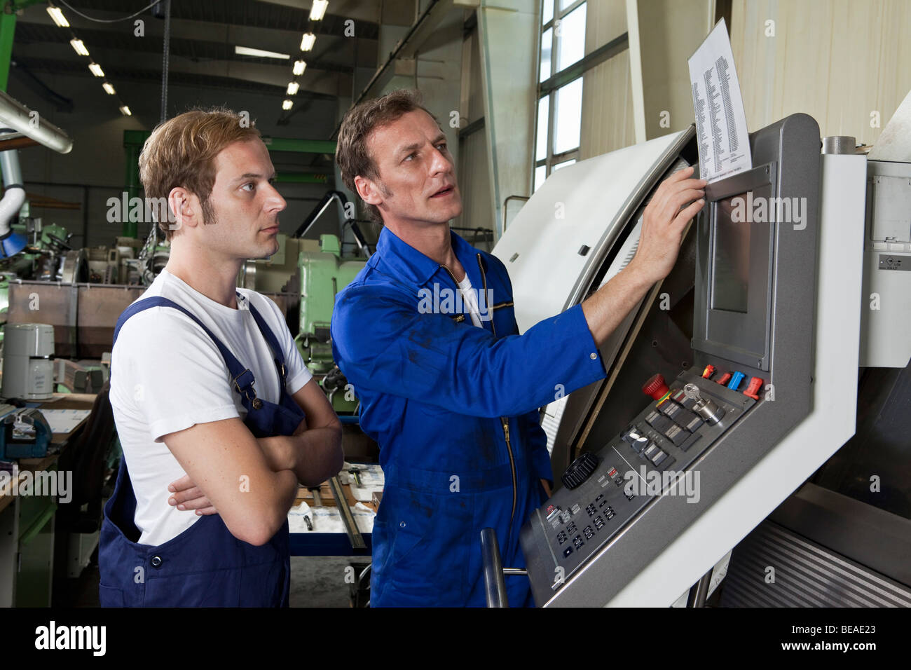 Two men working machine hi-res stock photography and images - Alamy