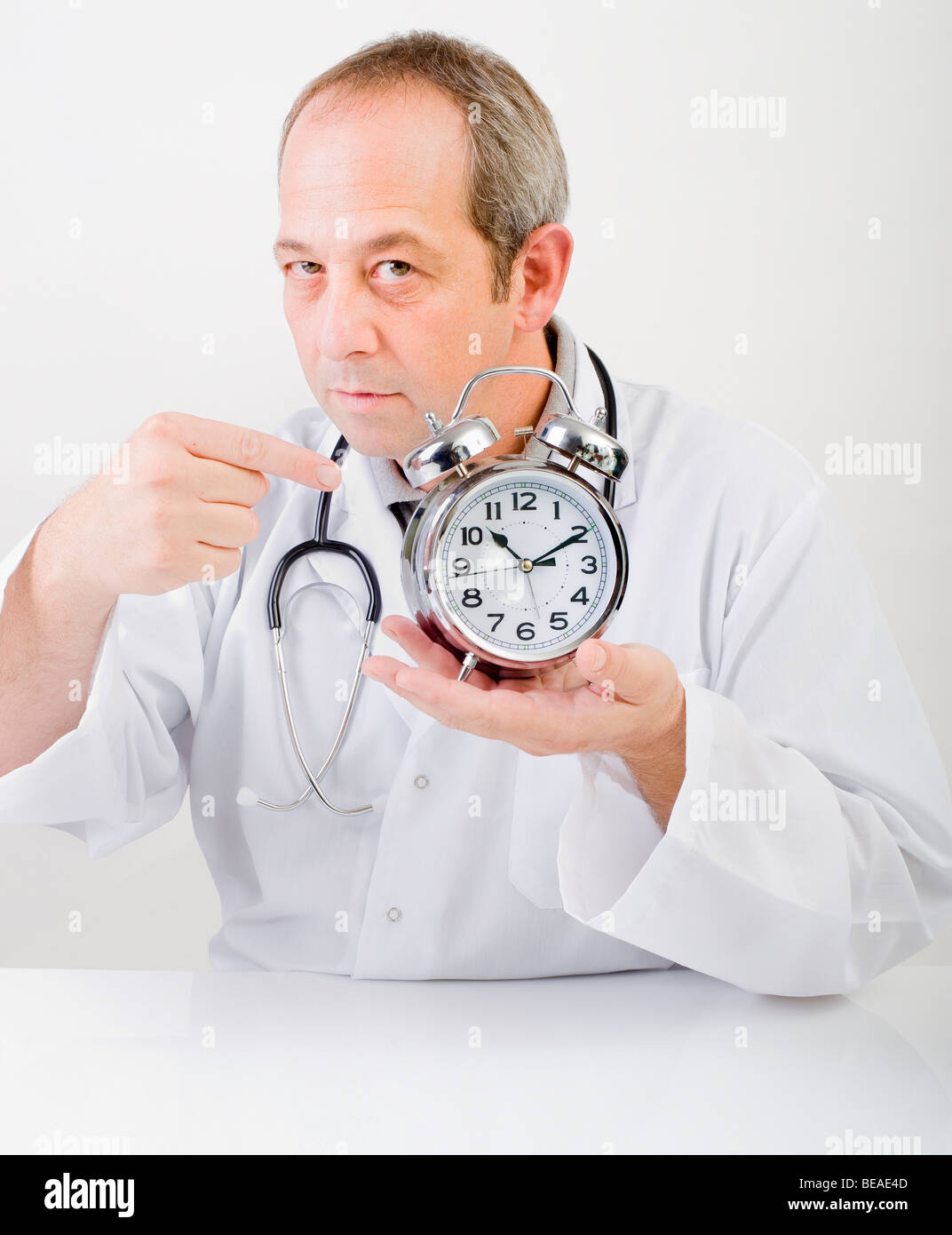doctor pointing at alarm clock Stock Photo - Alamy doctor pointing at alarm clock Stock Photo - Alamy