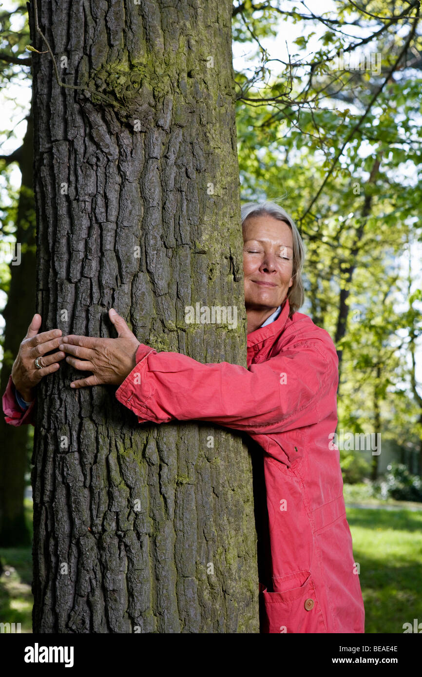 A senior woman hugging a tree Stock Photo - Alamy