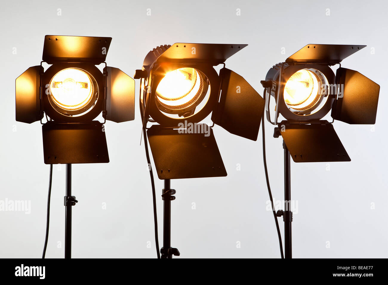 Three illuminated spotlights Stock Photo - Alamy