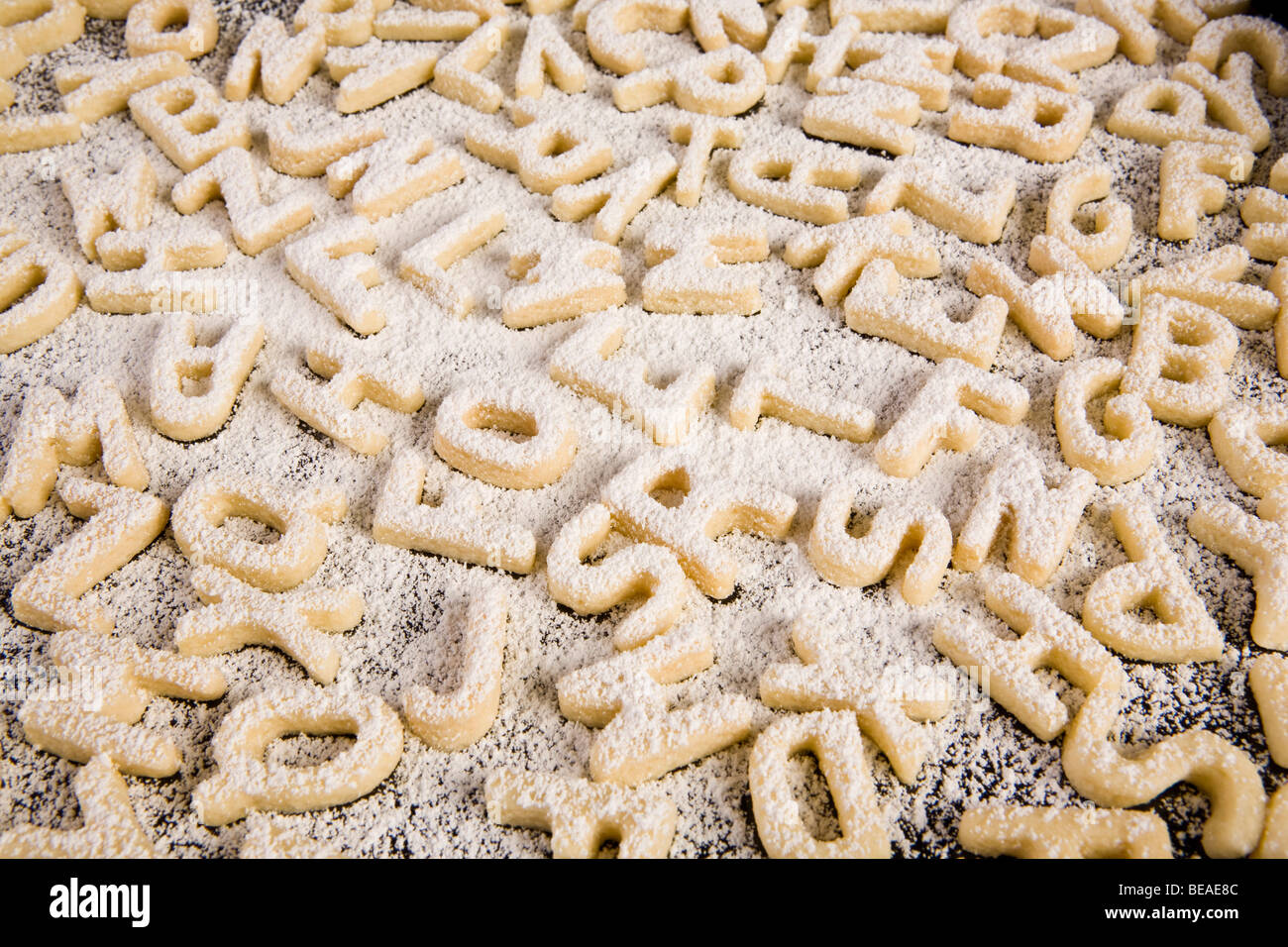 Letter cookies spread out with powdered sugar on top Stock Photo - Alamy
