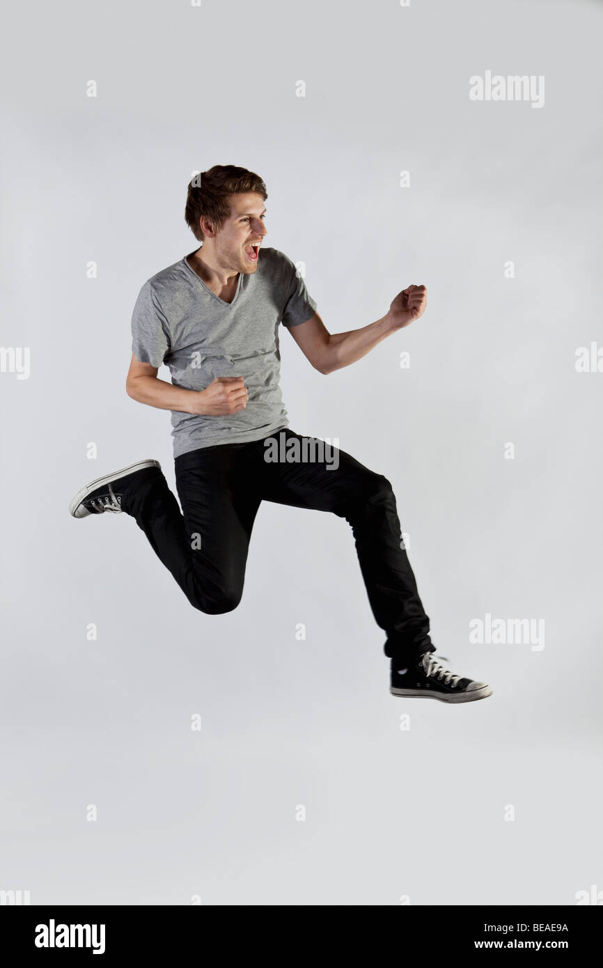 A man jumping in mid-air an excitement Stock Photo - Alamy