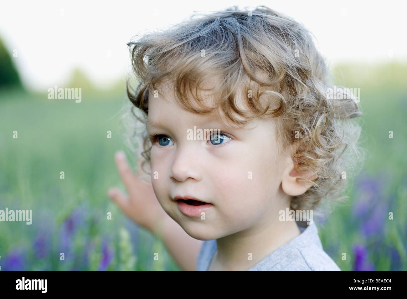A young boy looking away and pointing Stock Photo - Alamy