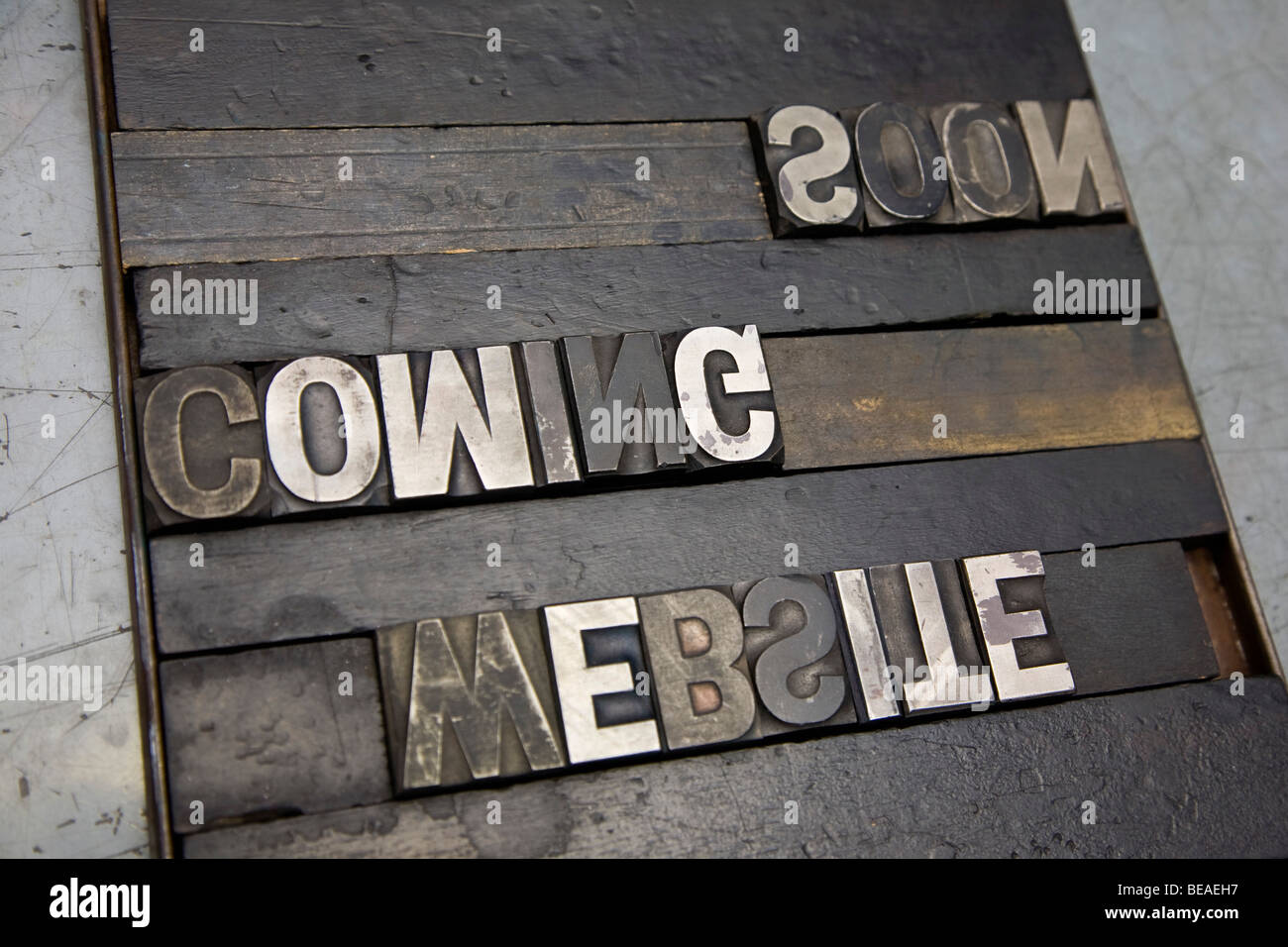 WEBSITE COMING SOON written backwards in metal letterpress letters ...
