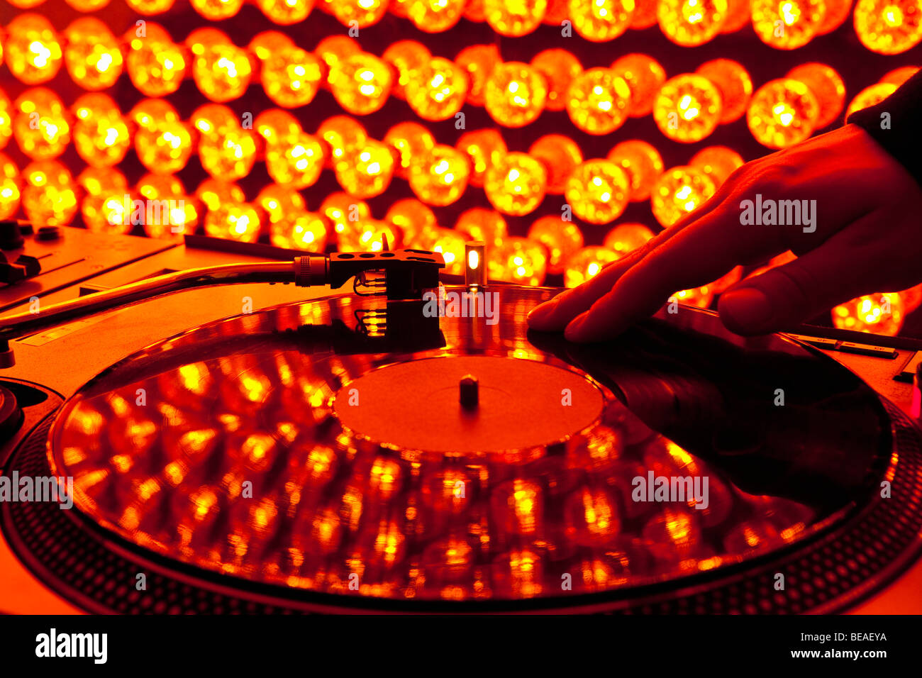 A DJ scratching a record at a nightclub Stock Photo - Alamy