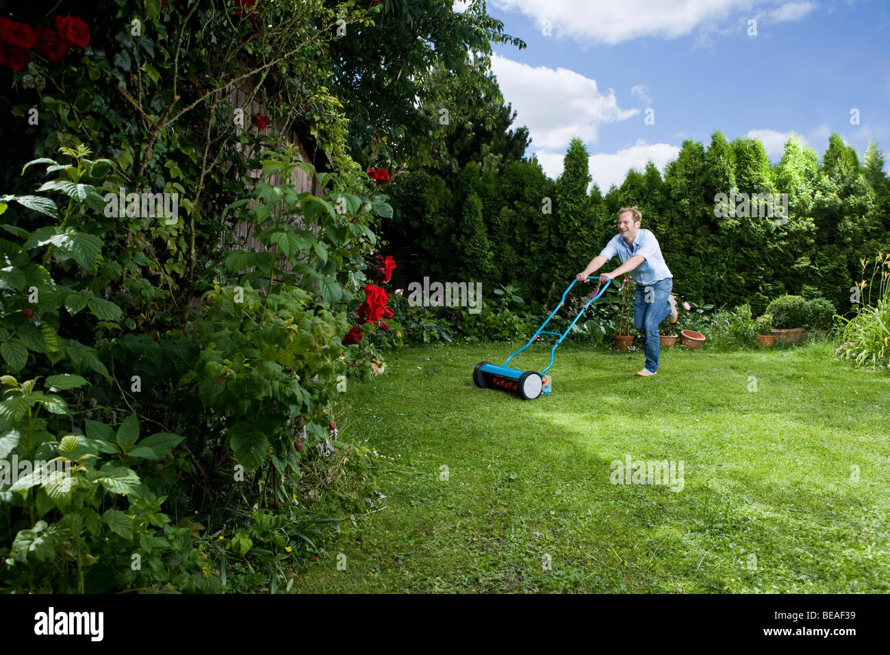 Man pushing mower hi-res stock photography and images - Alamy