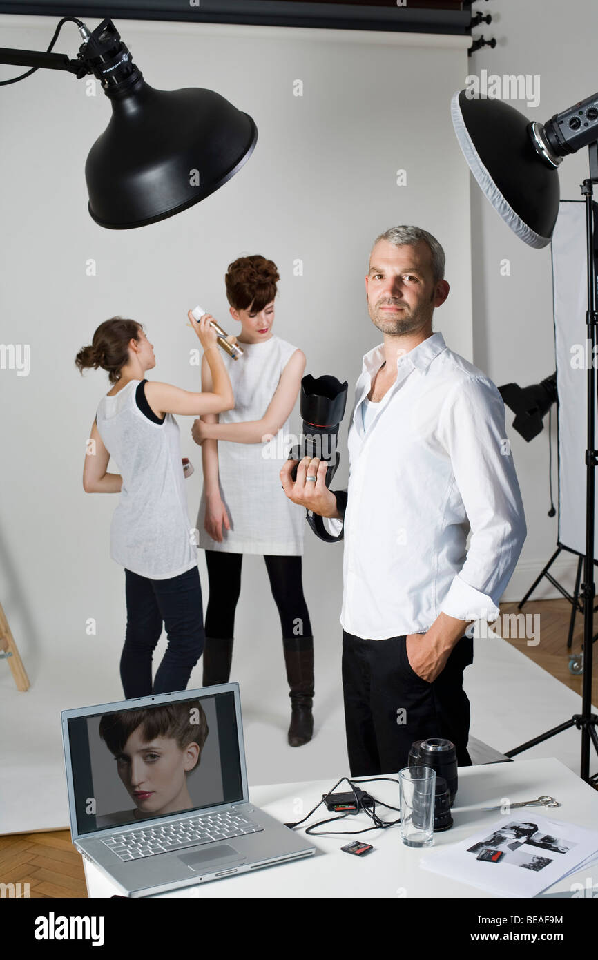 A photographer, model and make-up artist on set of a fashion shoot ...