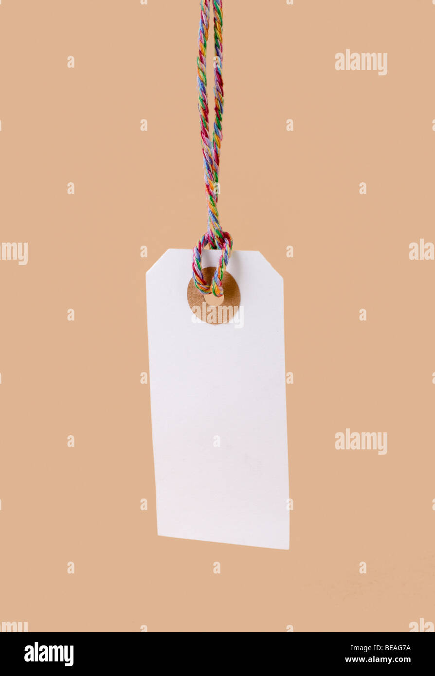 hanging label with colorful string Stock Photo - Alamy