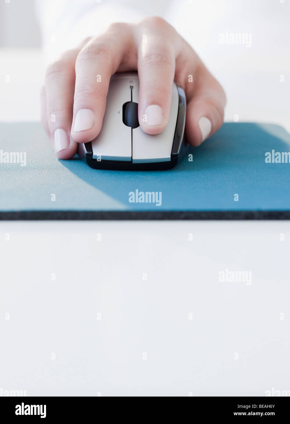 Woman clicking on computer mouse Stock Photo - Alamy
