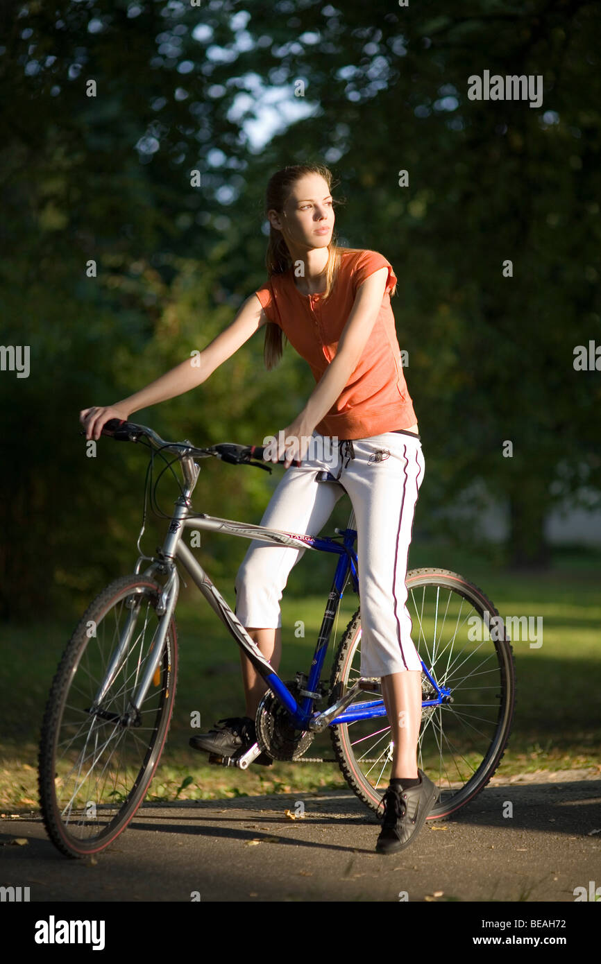 Young woman riding bicycle Stock Photo - Alamy