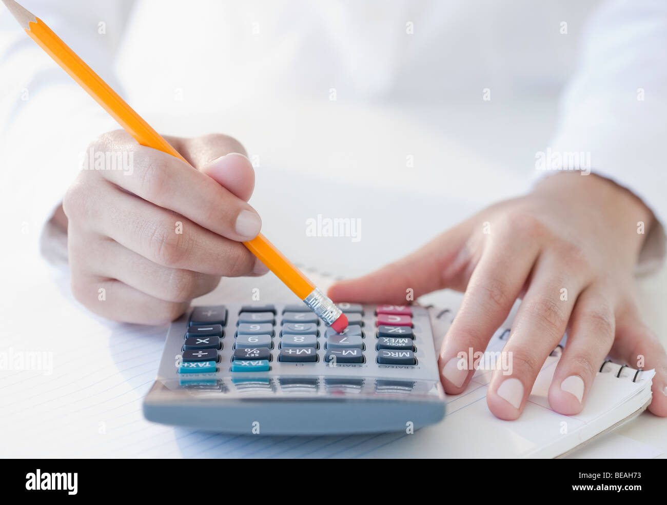 Woman using calculator Stock Photo - Alamy