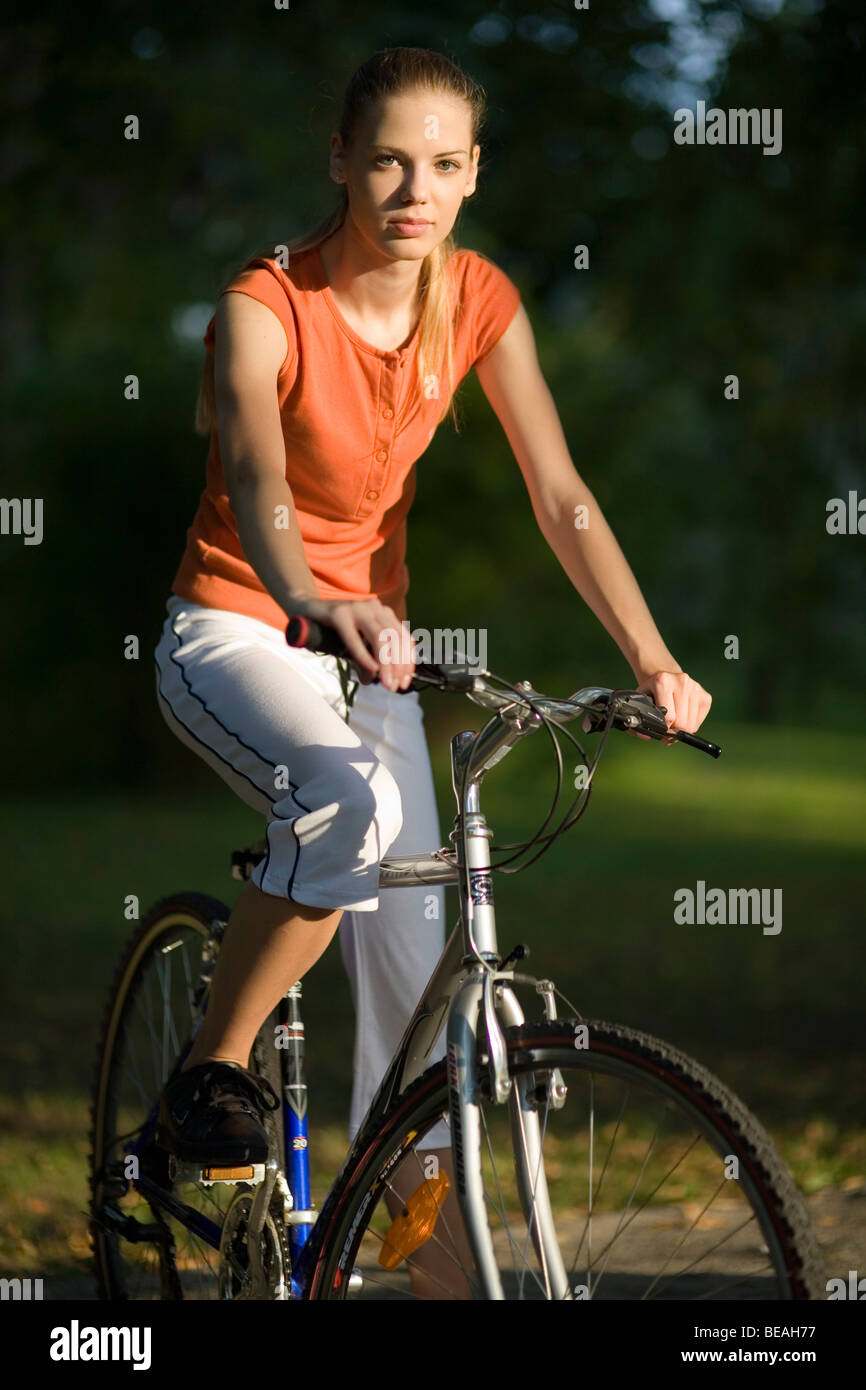 Young woman riding bicycle Stock Photo - Alamy