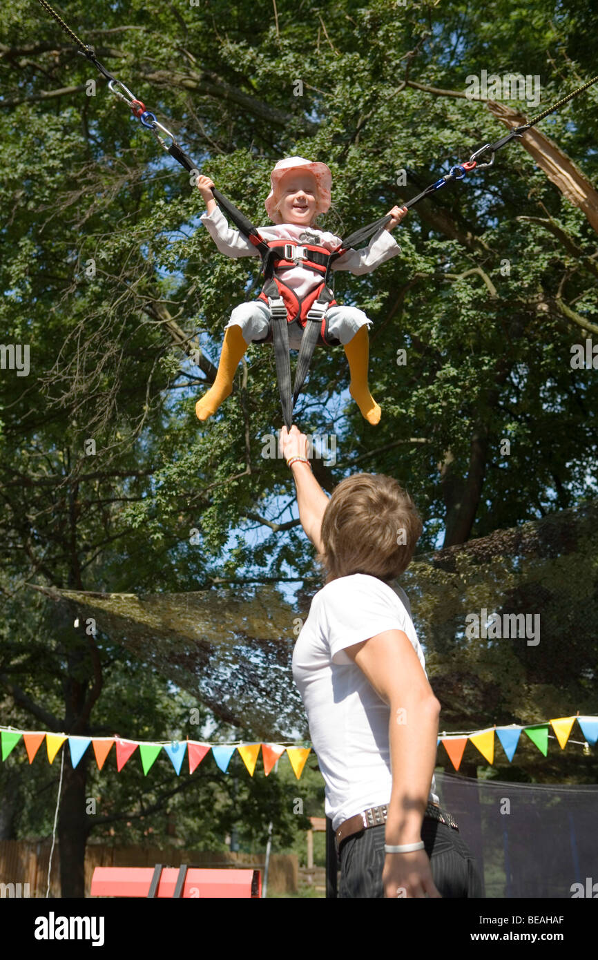 Little girl on bungee jumping Stock Photo - Alamy