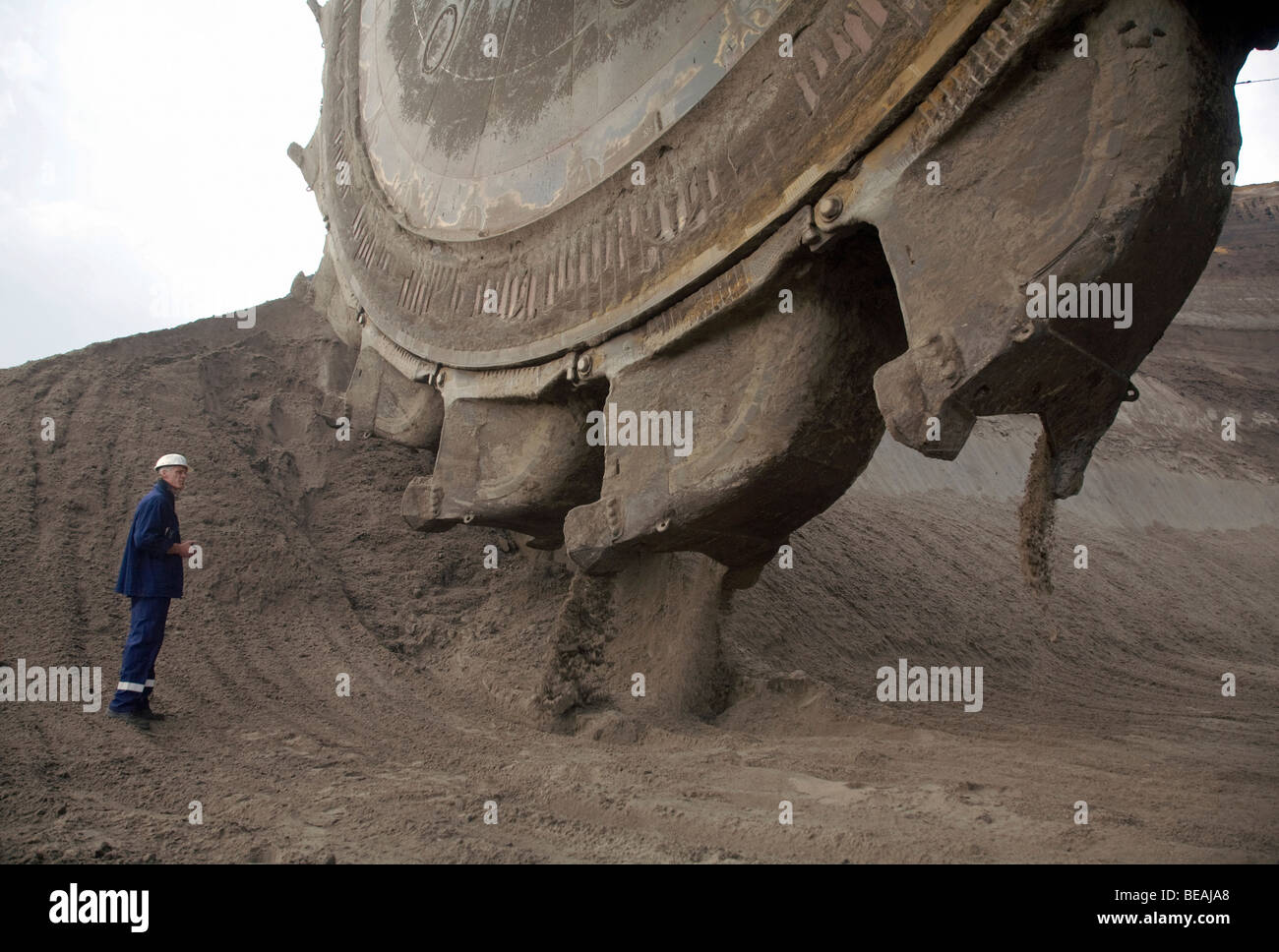 Worker standing under a bucket-wheel, Grevenbroich, Germany Stock Photo ...