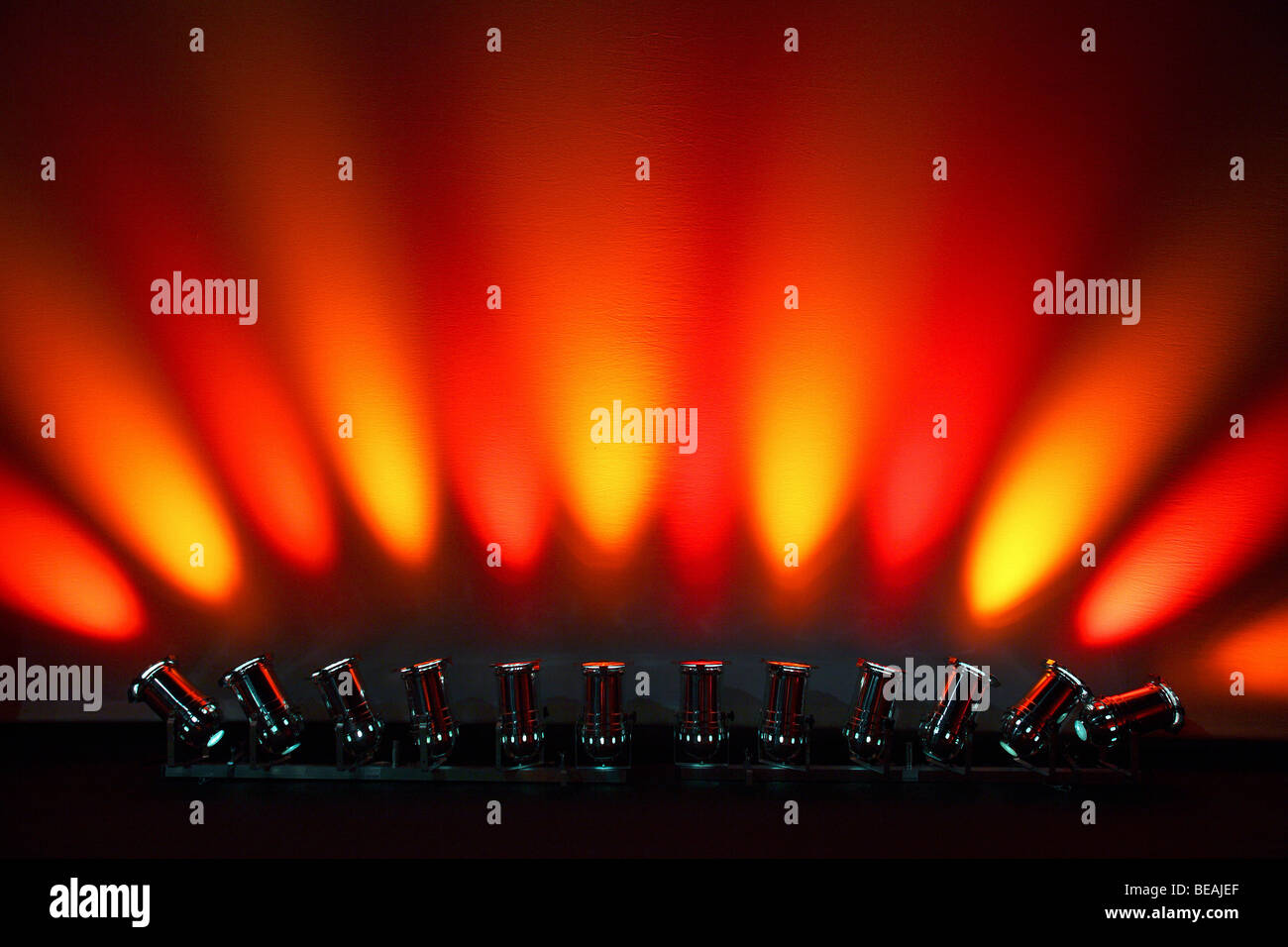 Metal spotlights radiating red and yellow light Stock Photo - Alamy