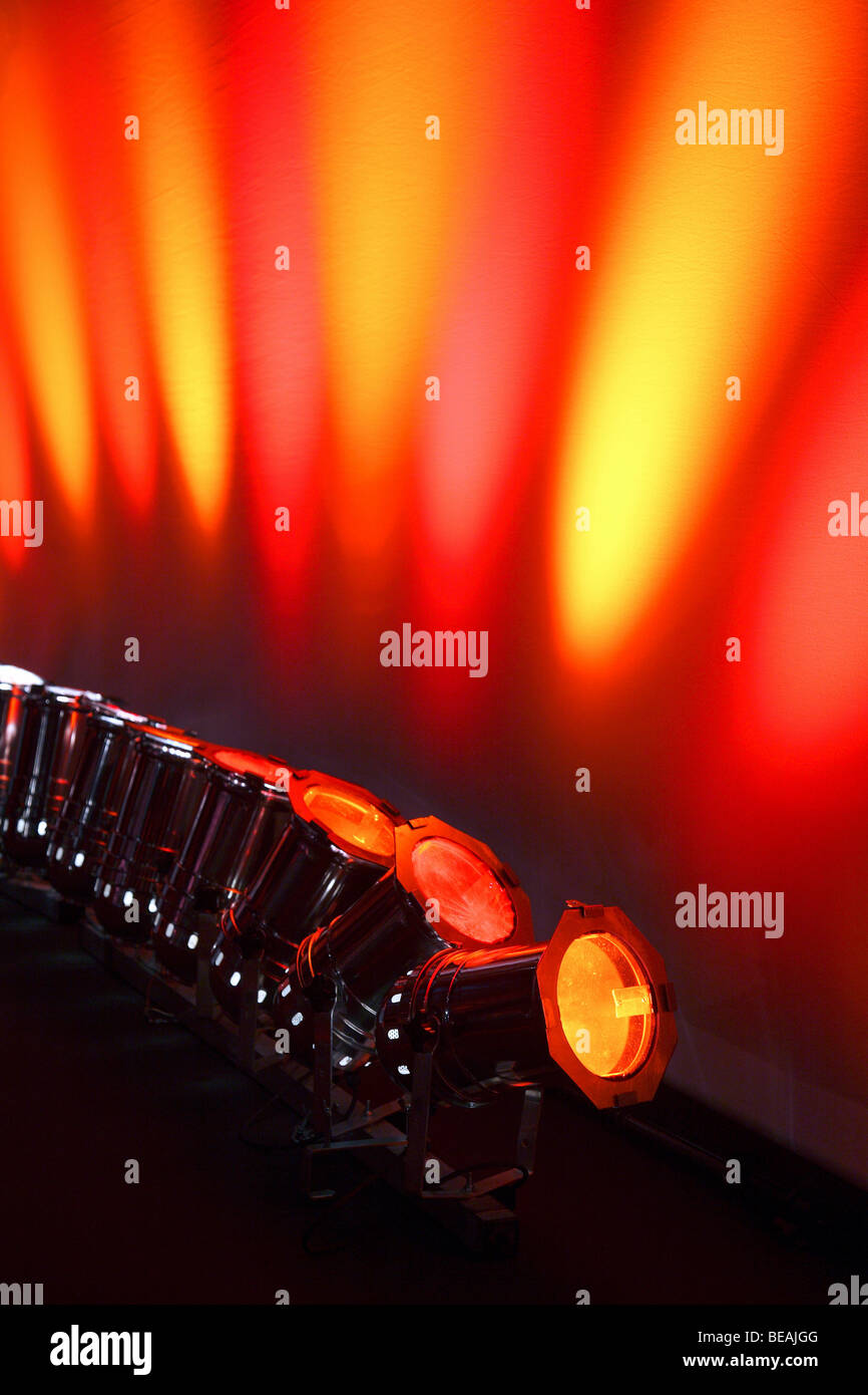Metal spotlights radiating red and yellow light Stock Photo - Alamy