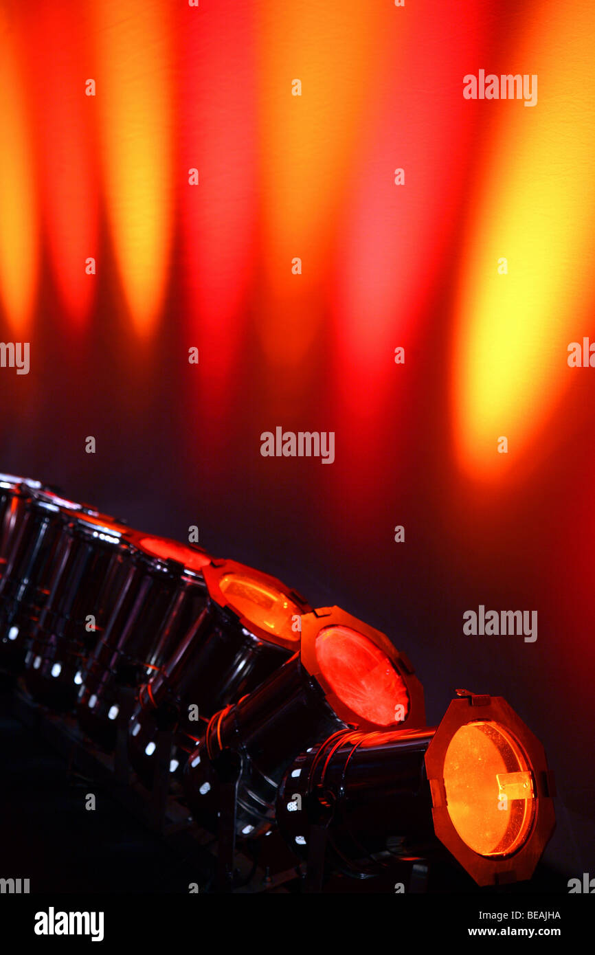 Metal spotlights radiating red and yellow light Stock Photo - Alamy