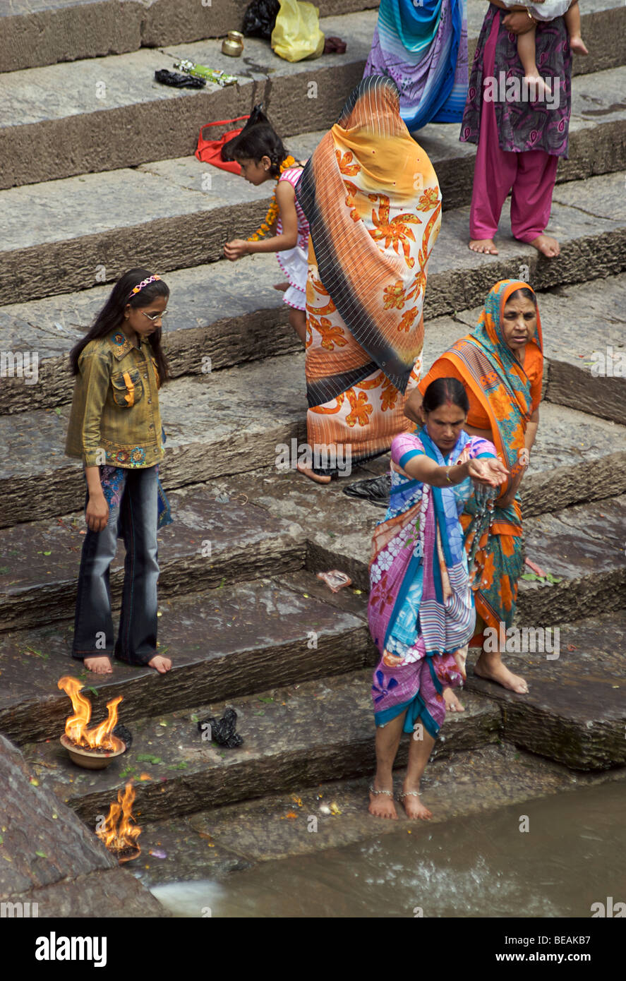 Nepalese Hindu women performing ritual in the the Bagmati river at ...