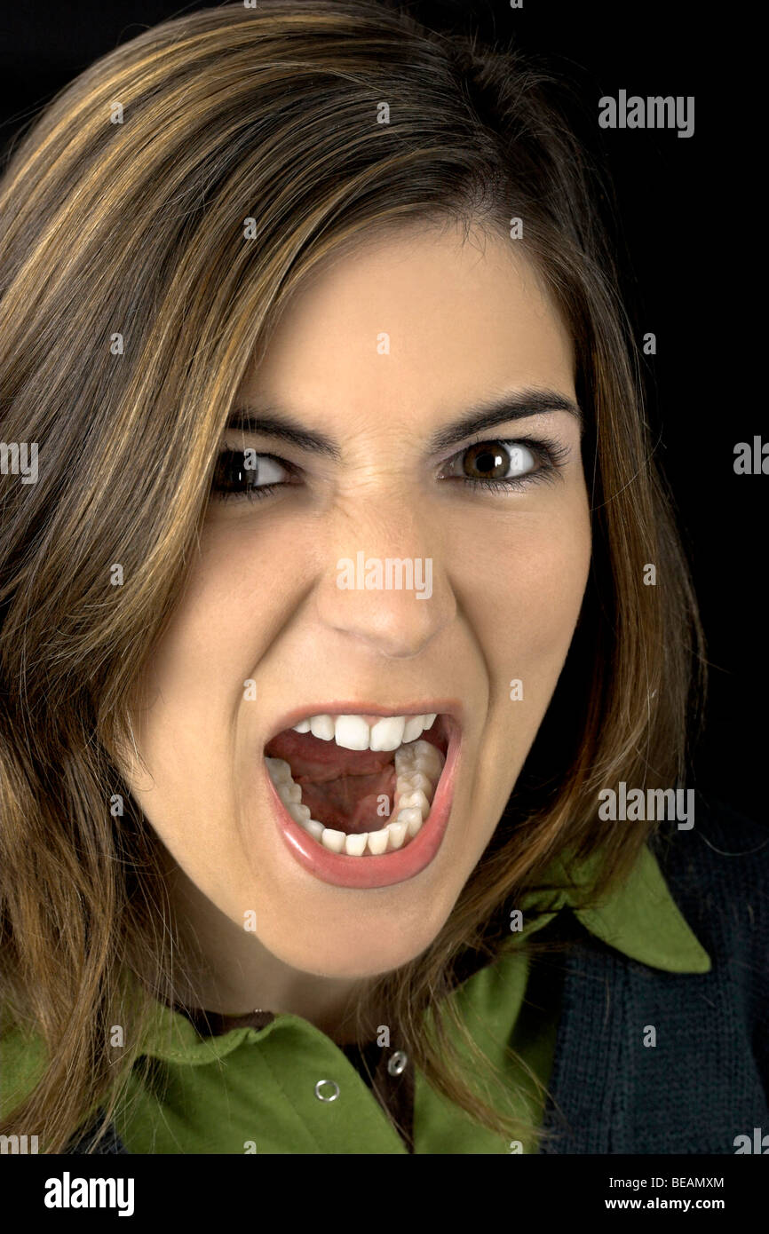 Portrait of a young attractive woman yelling Stock Photo - Alamy
