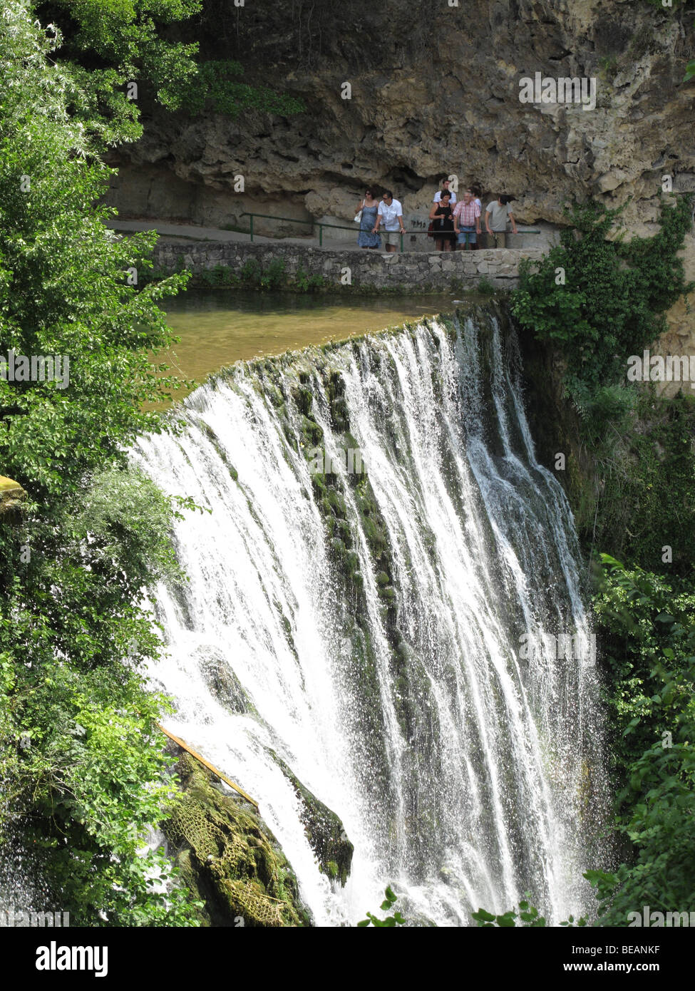 Tourist on sightseeing Pliva waterfalls in town of Jajce, Bosnia and ...