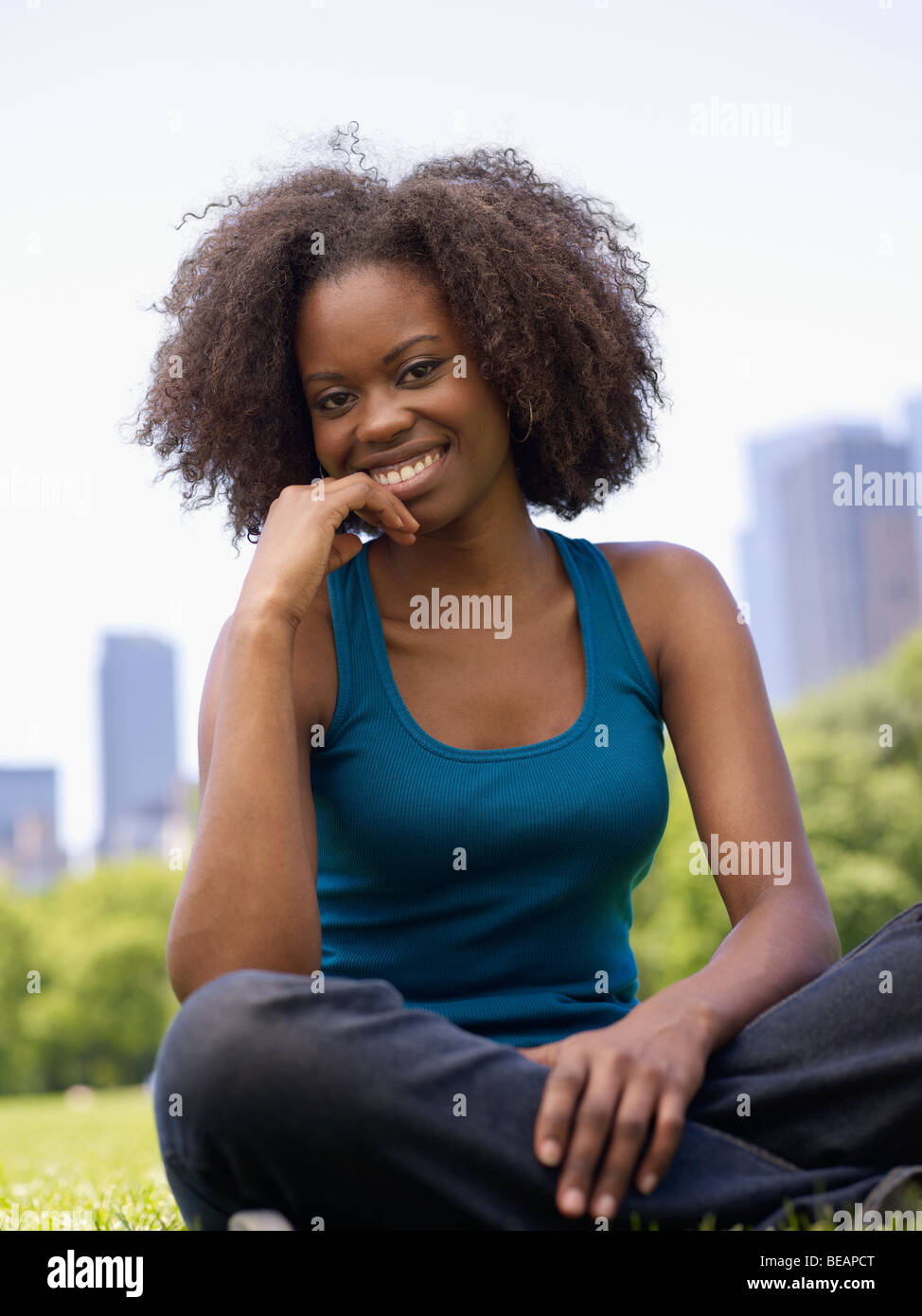 African woman smiling in park Stock Photo - Alamy