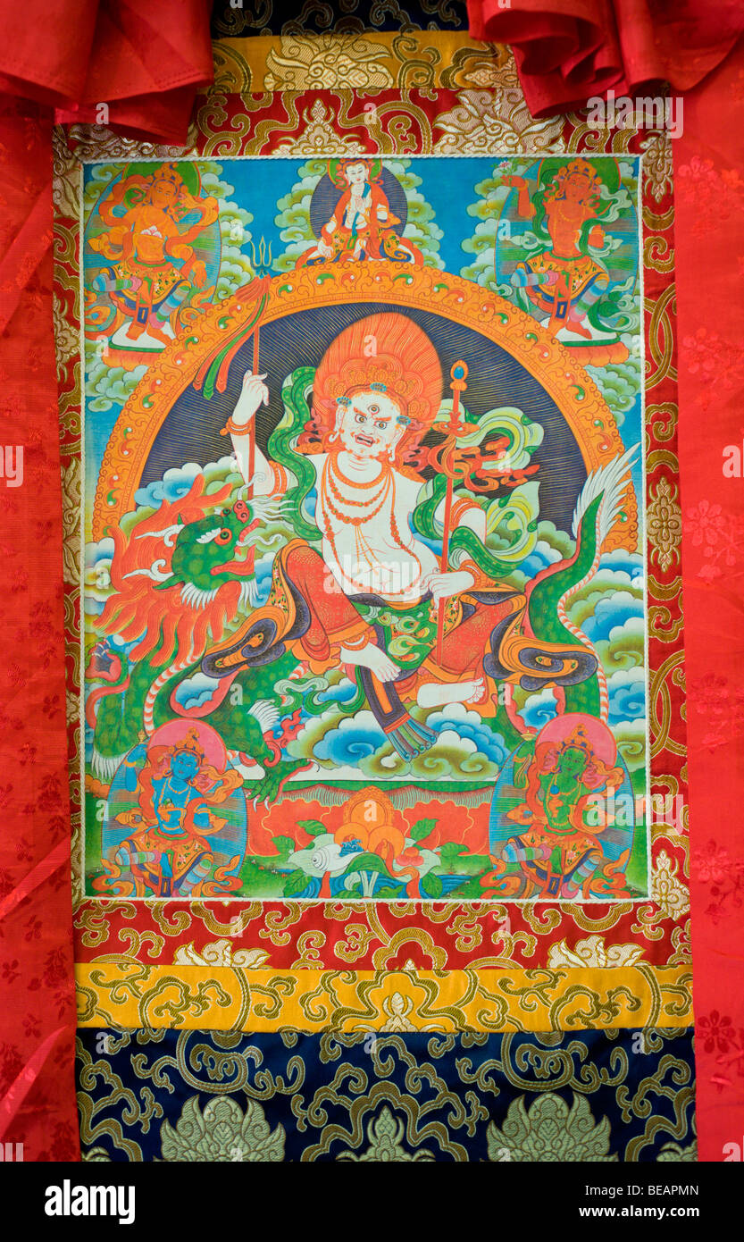 A Buddhist tapestry is hung in preparation for a religious ceremony ...