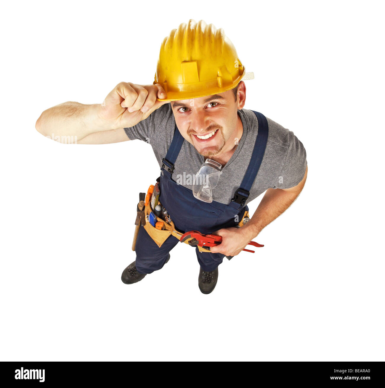 smiling caucasian young manual worker view from above isolated on white ...