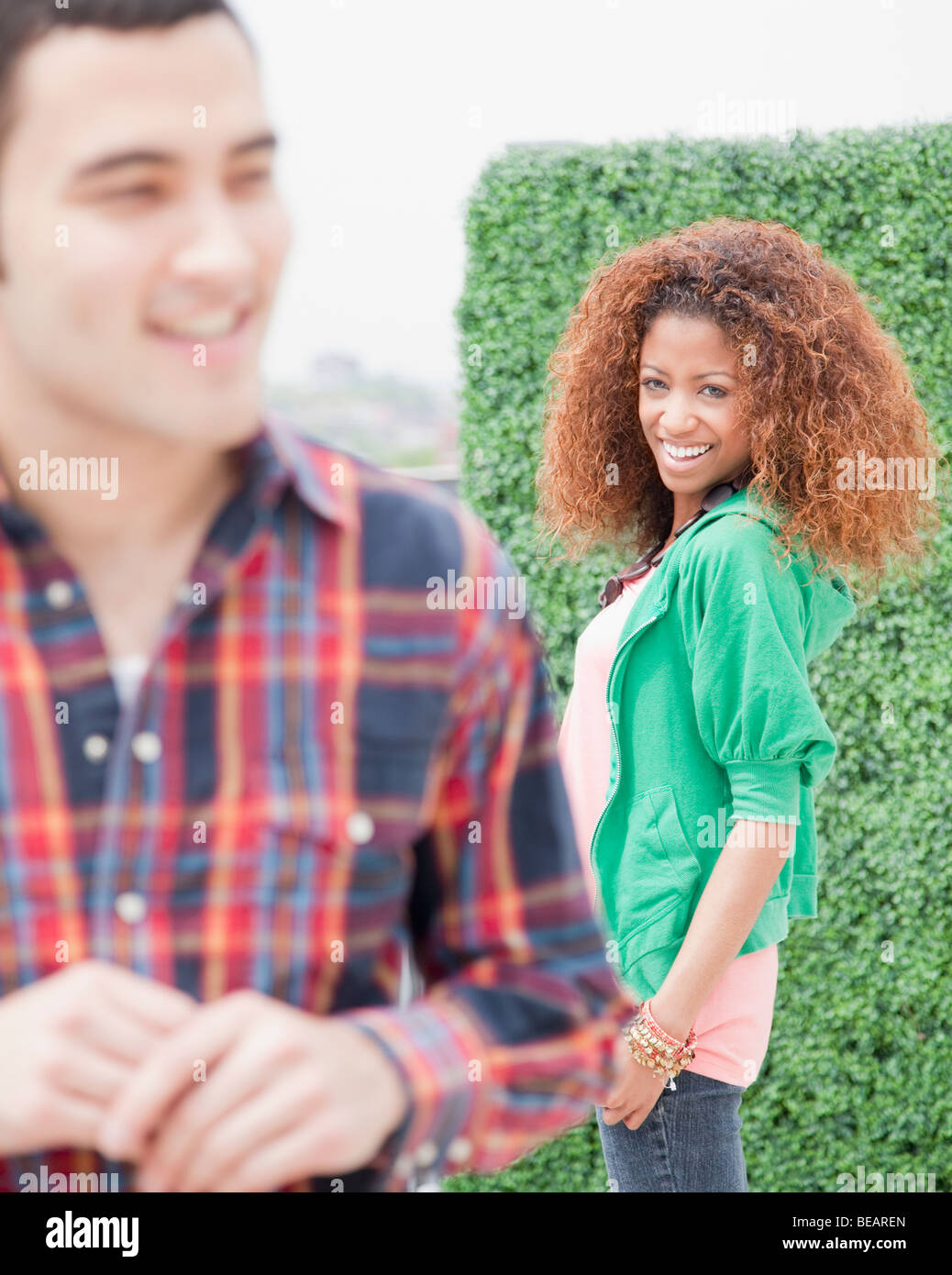 Woman smiling at passing man Stock Photo - Alamy