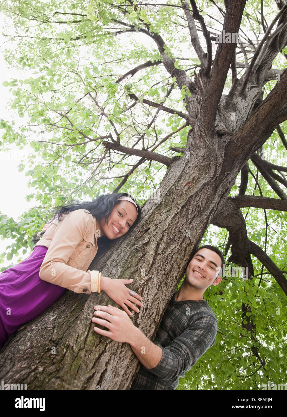 Couple hugging tree Stock Photo - Alamy