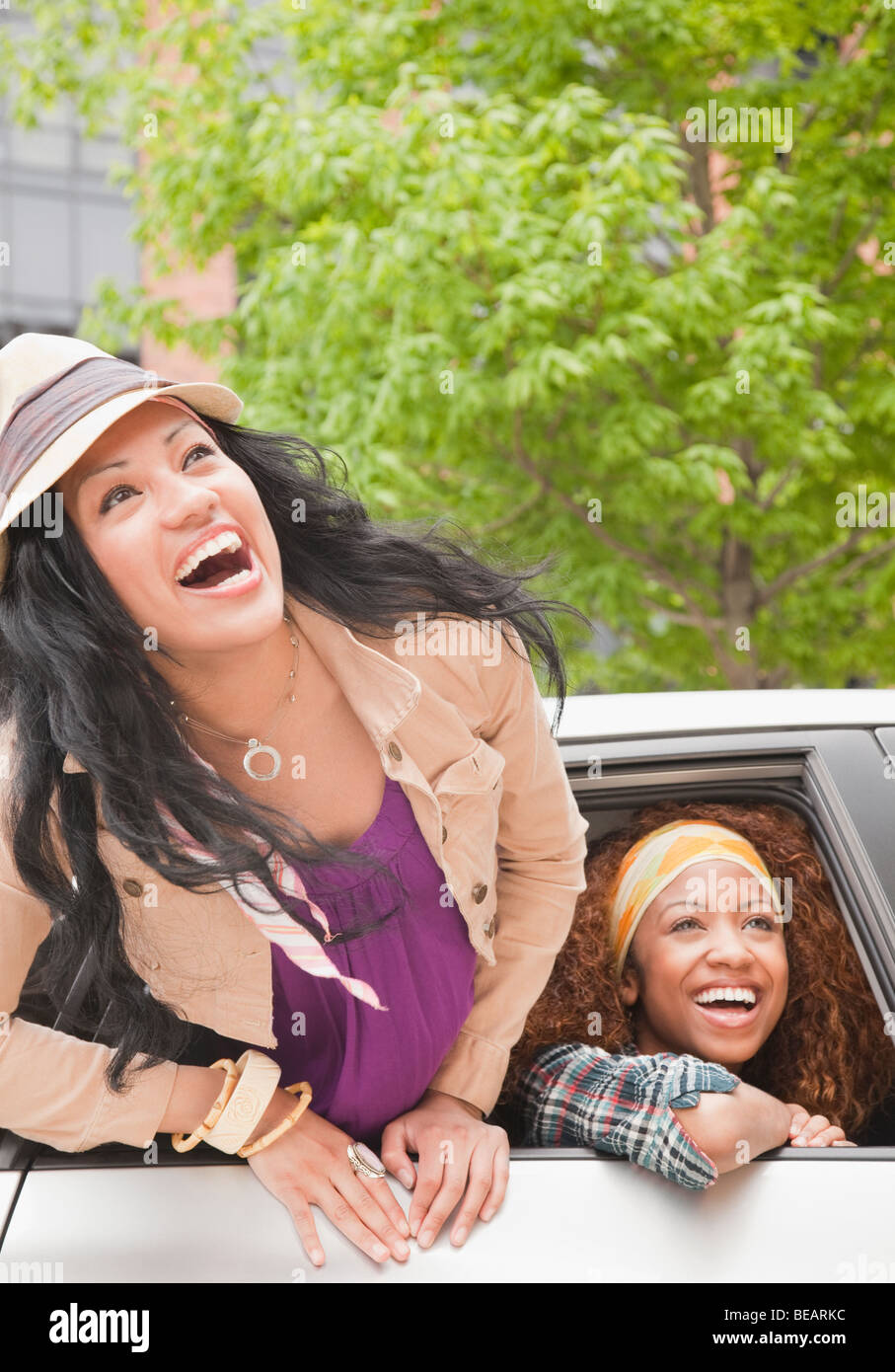 Women leaning out of car window Stock Photo - Alamy