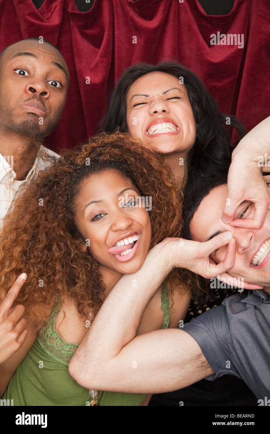 Friends making silly faces in photo booth Stock Photo - Alamy