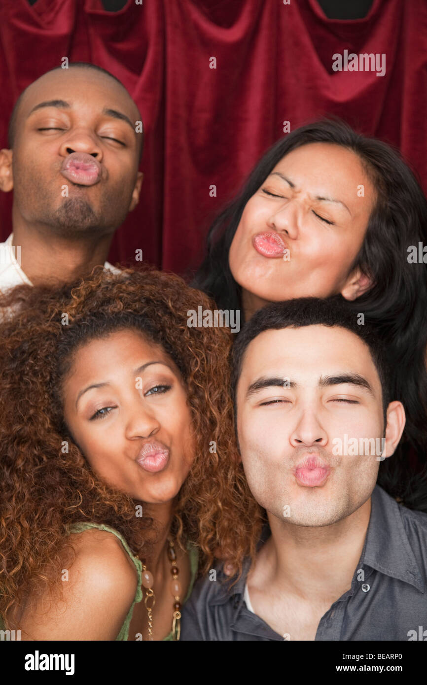 Friends puckering lips in photo booth Stock Photo - Alamy