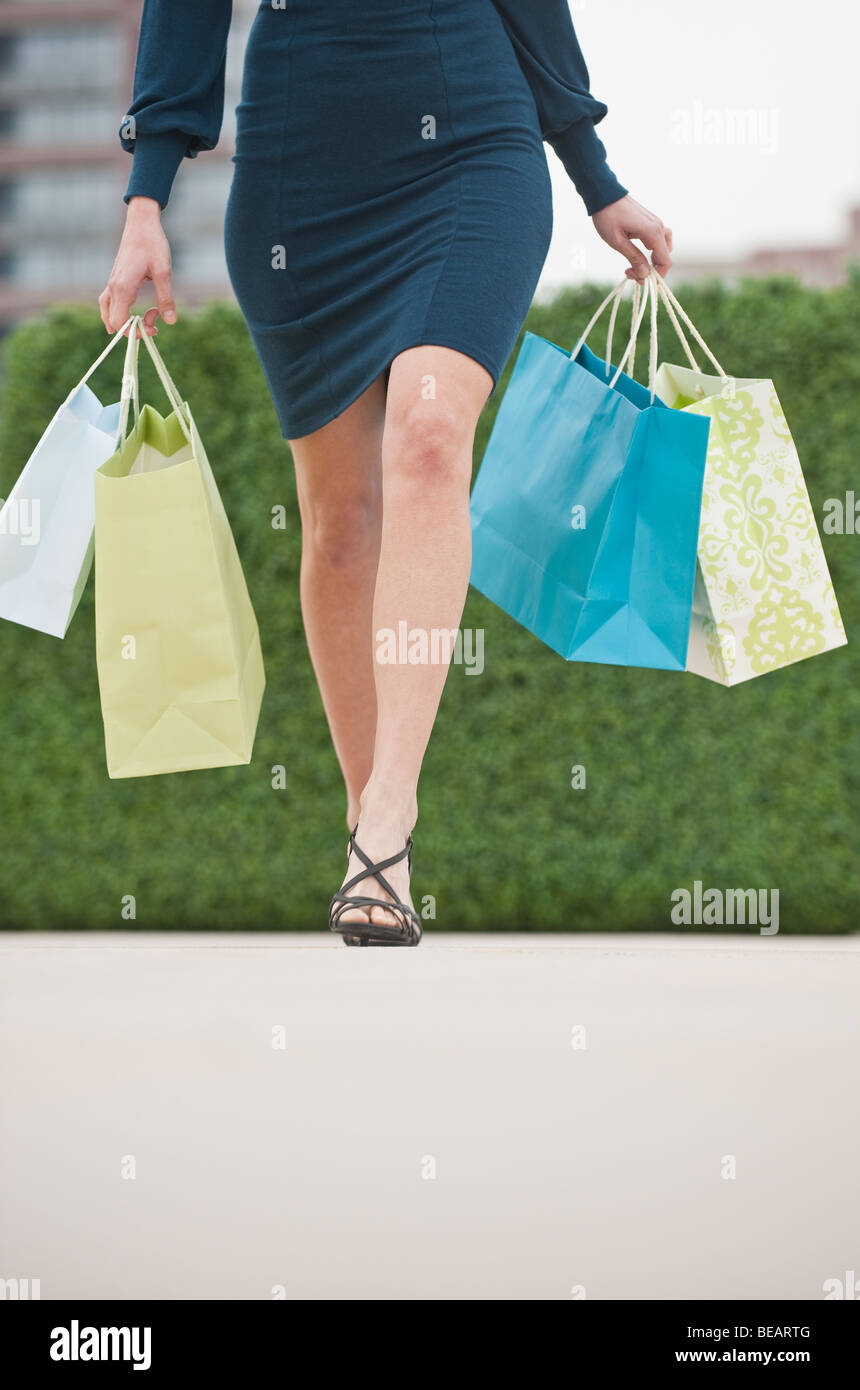 Hispanic woman carrying shopping bags Stock Photo - Alamy