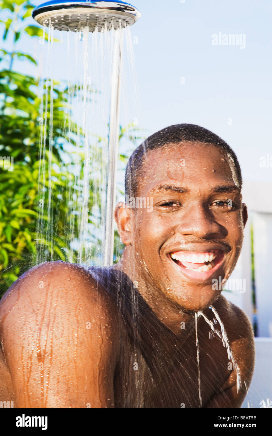African man using outdoor shower Stock Photo - Alamy