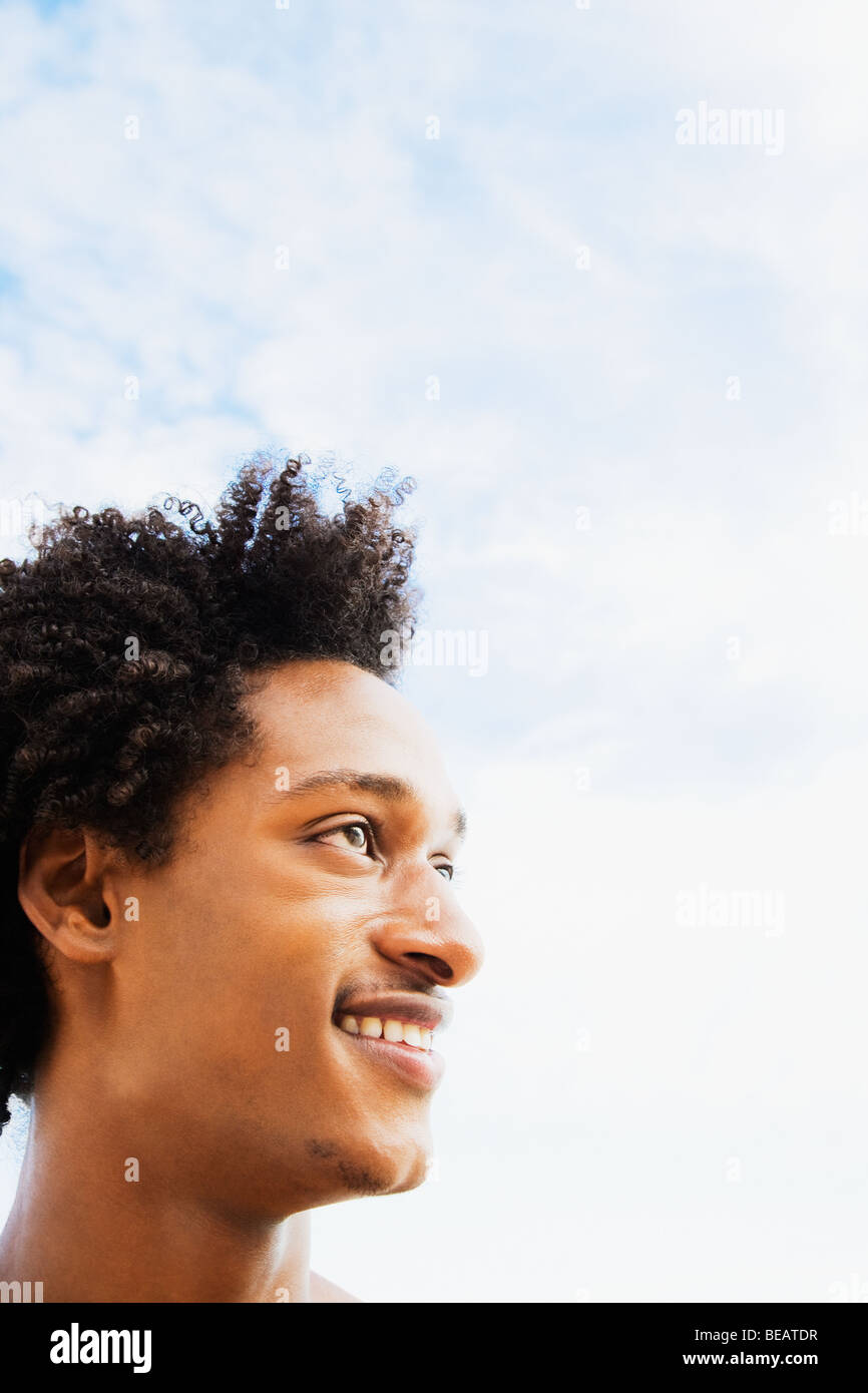 African man looking up and smiling Stock Photo - Alamy